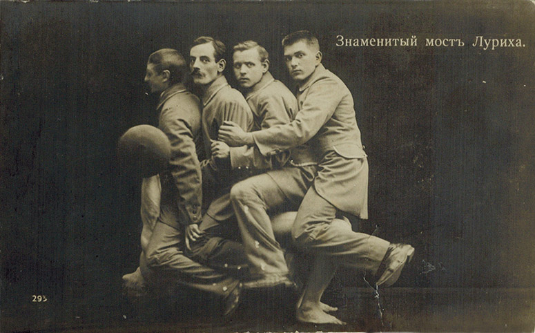 4 Russian men sitting on a strong man | MATTHEW'S ISLAND